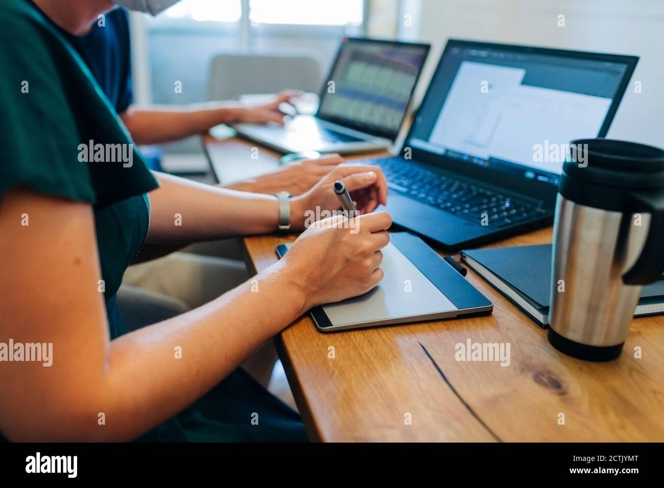 Female professional using graphics tablet at office Stock Photo - Alamy