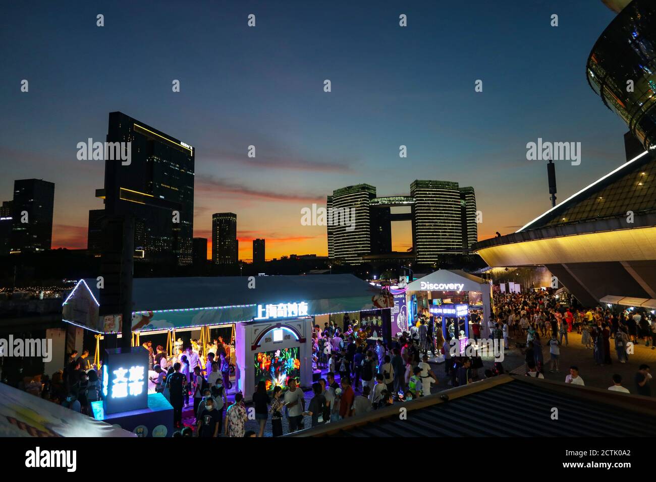 People walk around and shop at the "2020 Amazing Night in Hangzhou", a ...