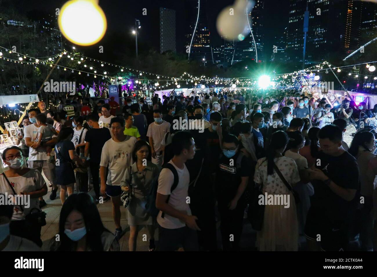 People walk around and shop at the "2020 Amazing Night in Hangzhou", a ...