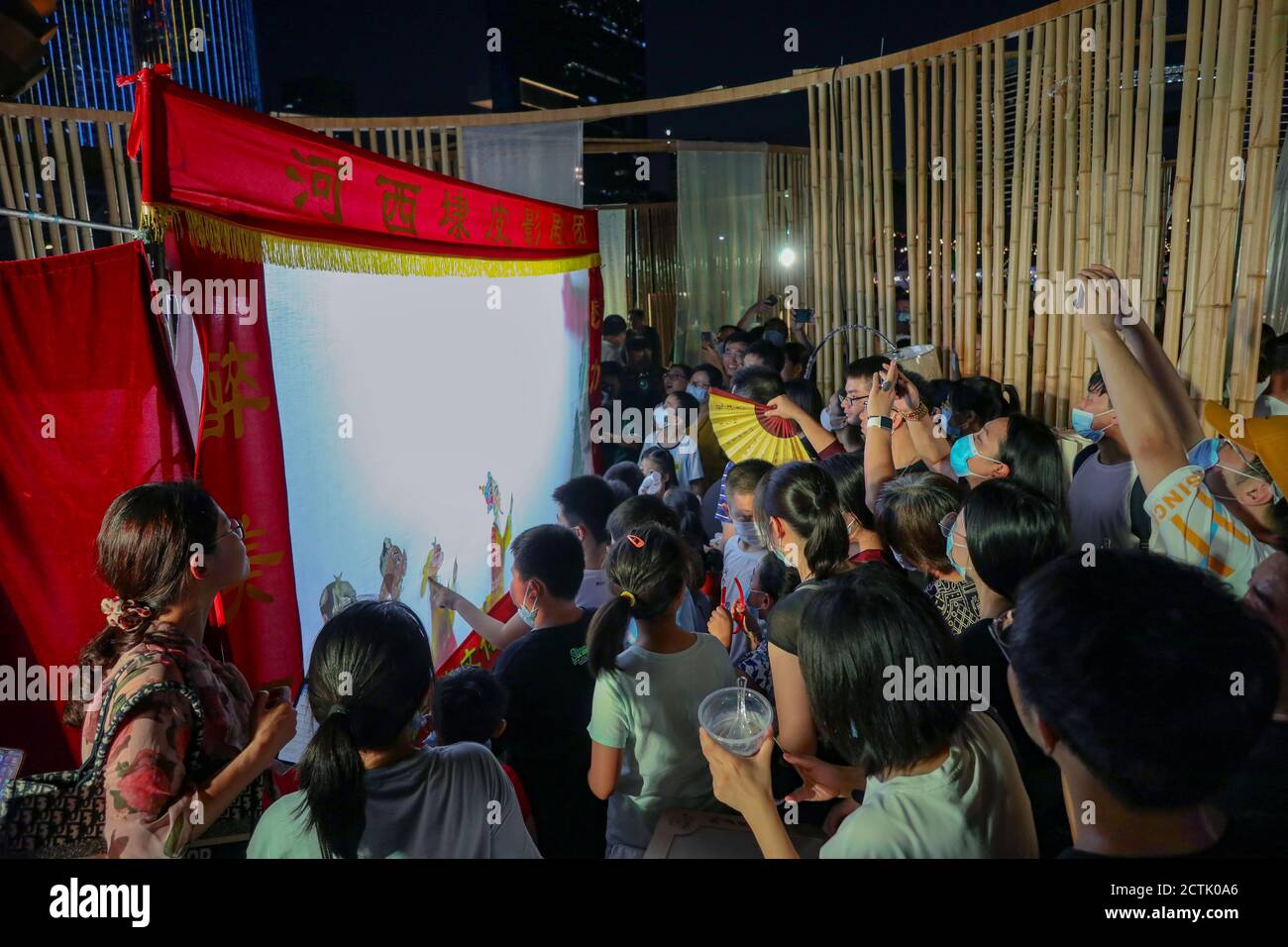 People walk around and shop at the "2020 Amazing Night in Hangzhou", a ...