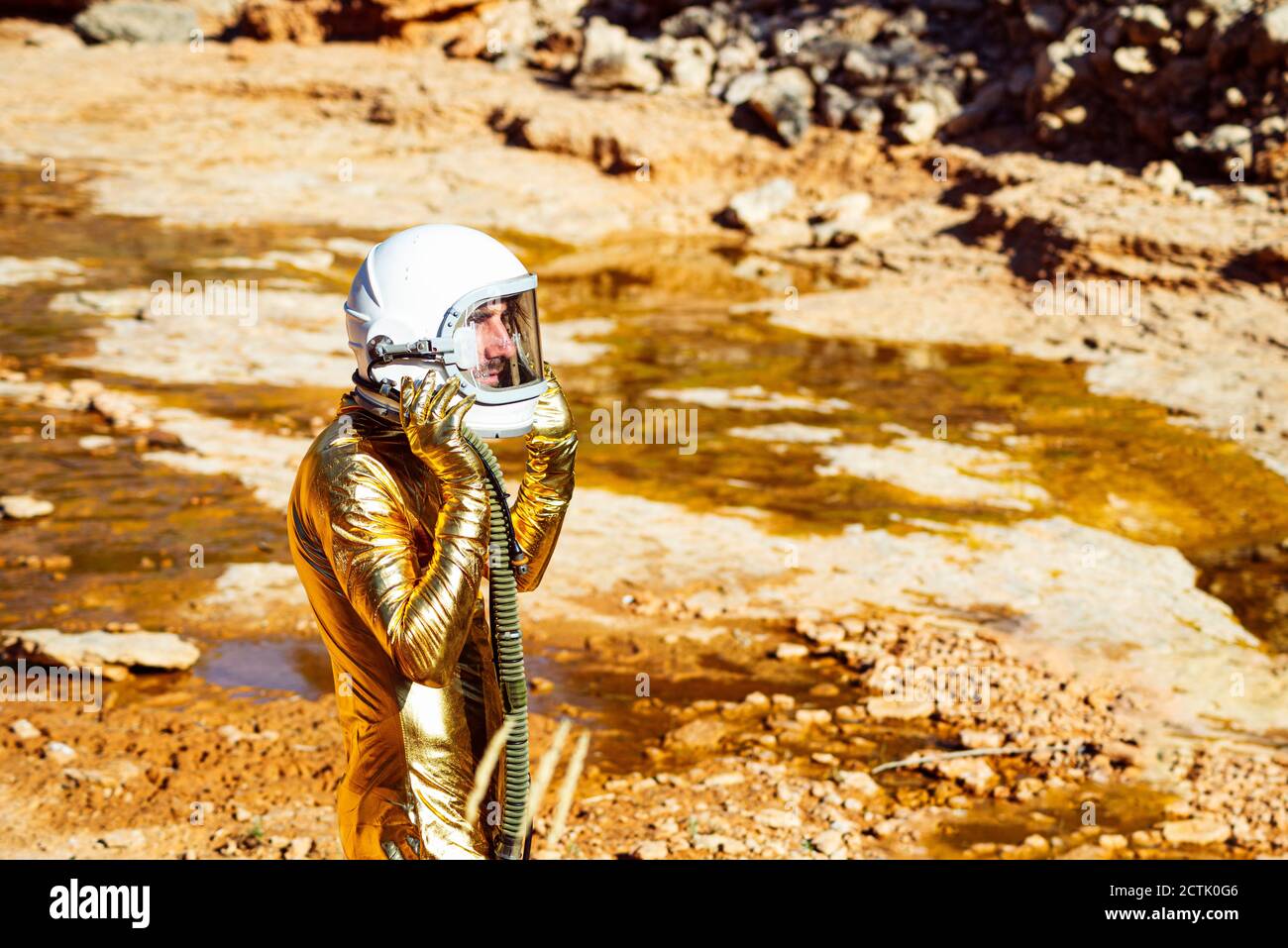 Astronaut wearing space helmet while looking away on moon Stock Photo ...
