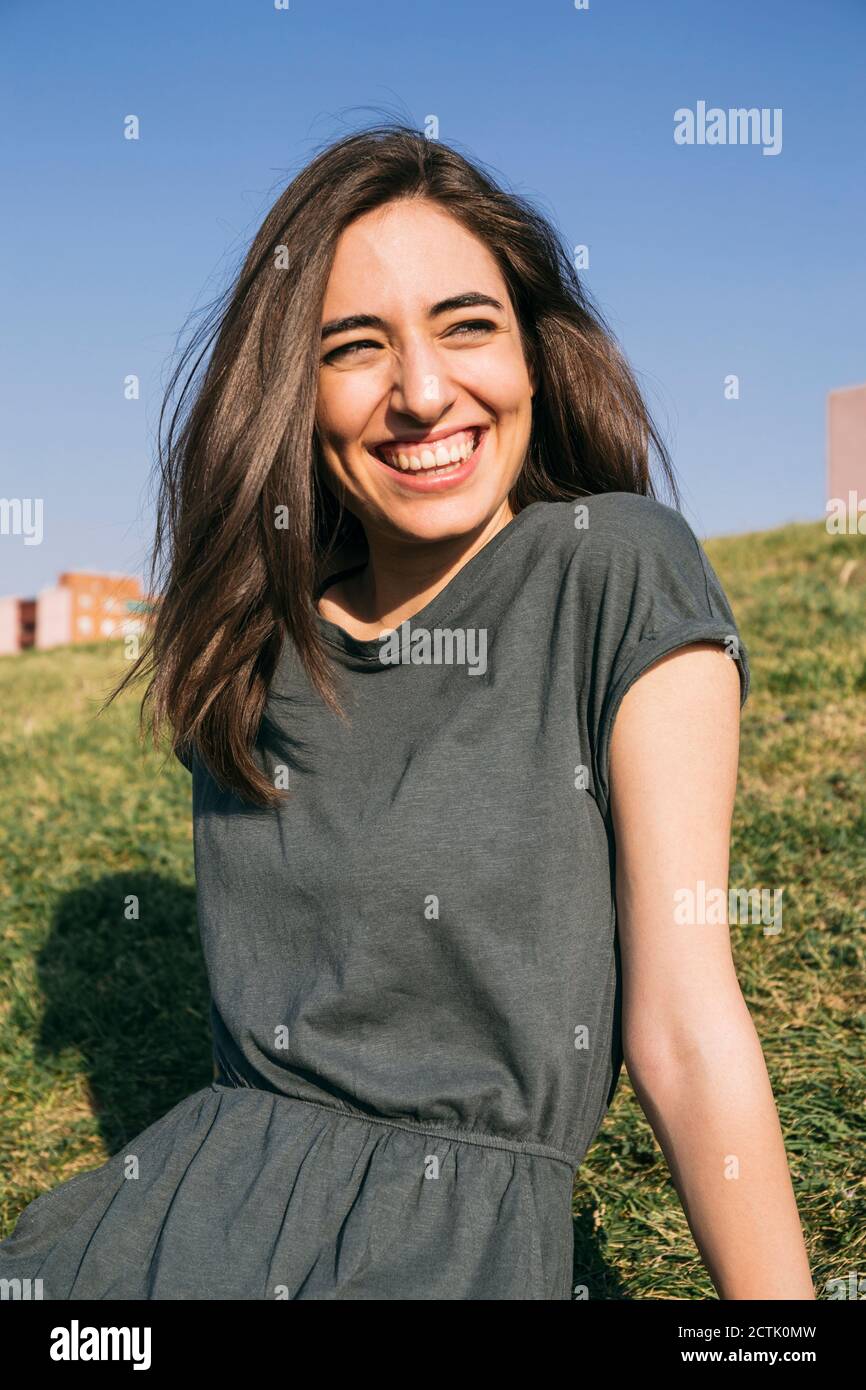 Beautiful woman sitting on grass hi-res stock photography and images - Alamy