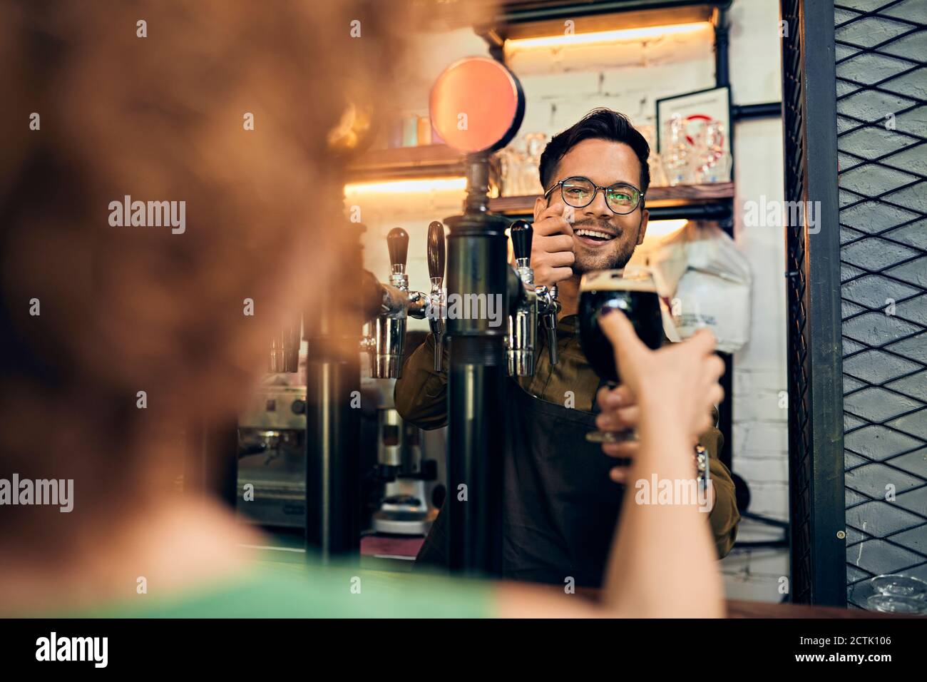 Two men and woman drinking bar hi-res stock photography and images - Alamy