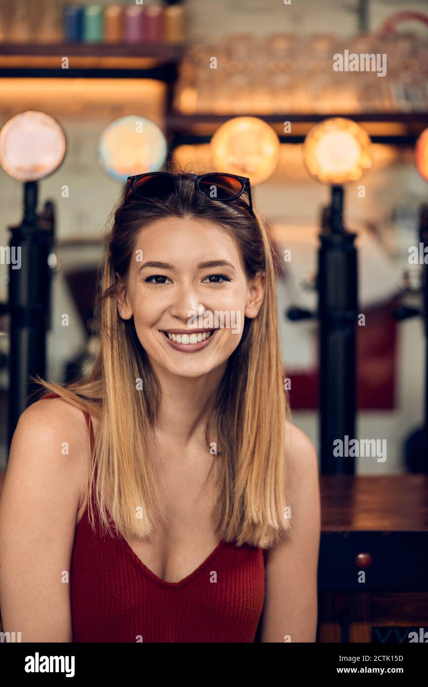 Portrait of a smiling woman in a pub Stock Photo - Alamy