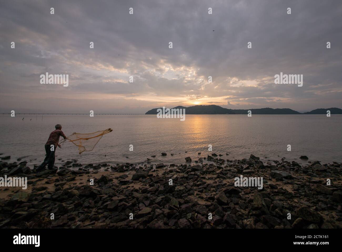 Batu Kawan, Penang/Malaysia - Mar 16 2017: Fisherman catch fish with ...