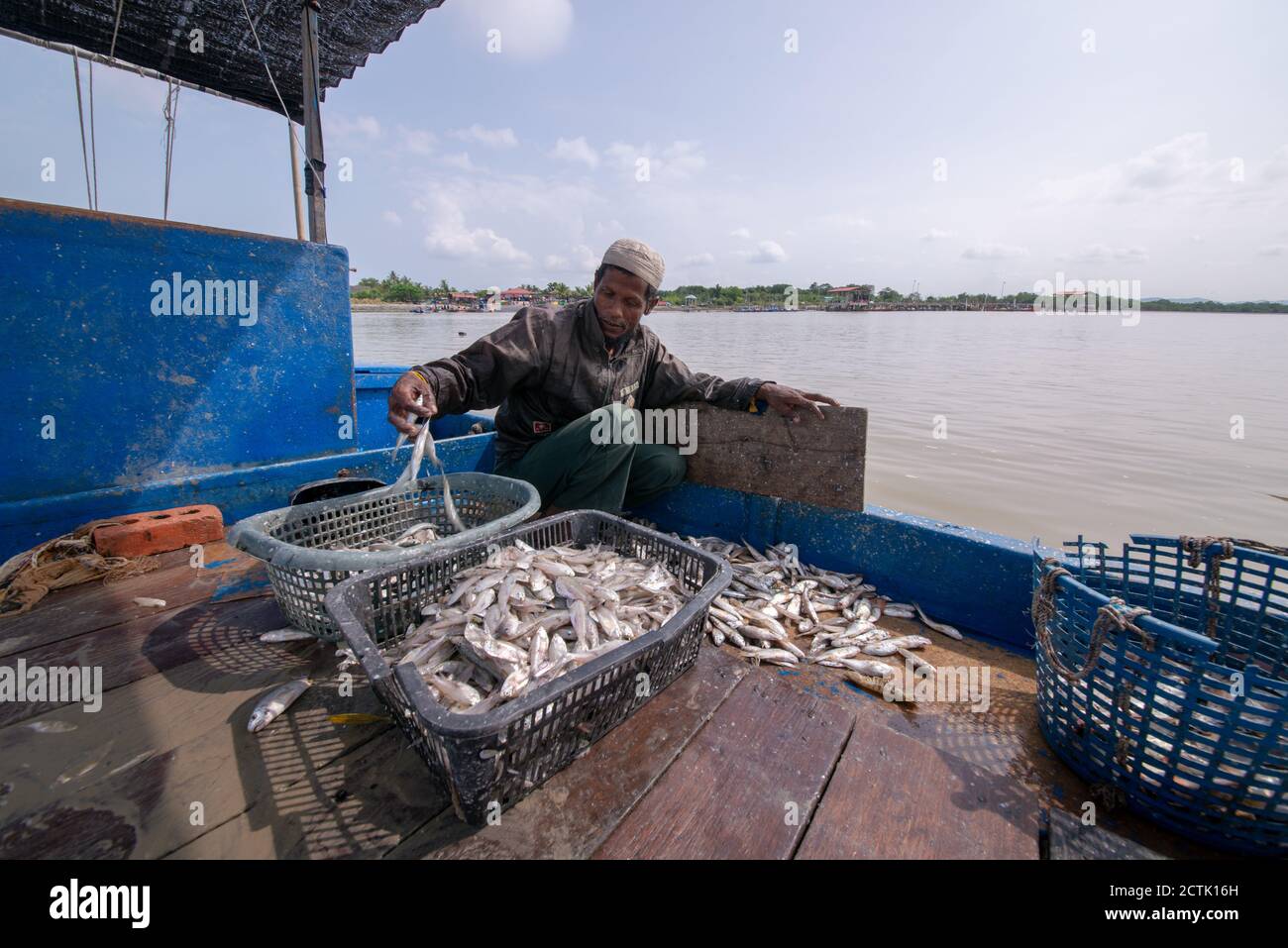 Kuala Muda, Penang/Malaysia - Mar 19 2017: Fisherman put the fish into ...