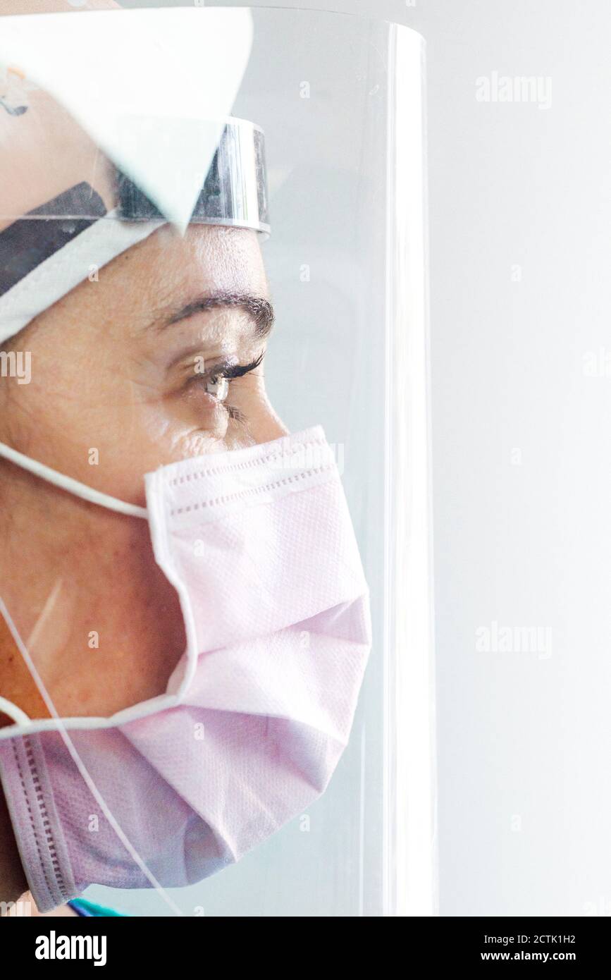 Close-up of doctor face wearing protective face mask and face shield at ...