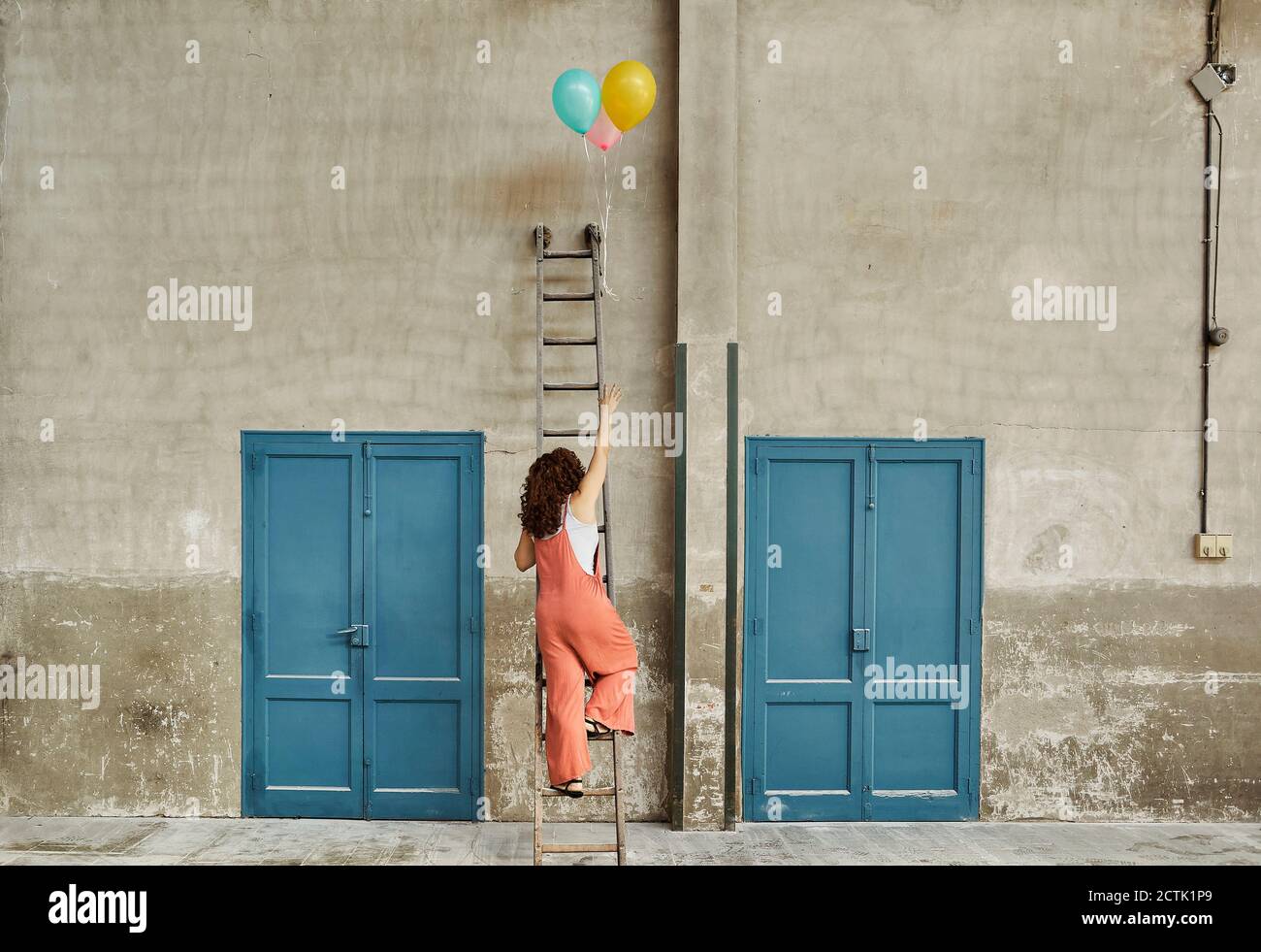 Woman climbing ladder hi-res stock photography and images - Alamy