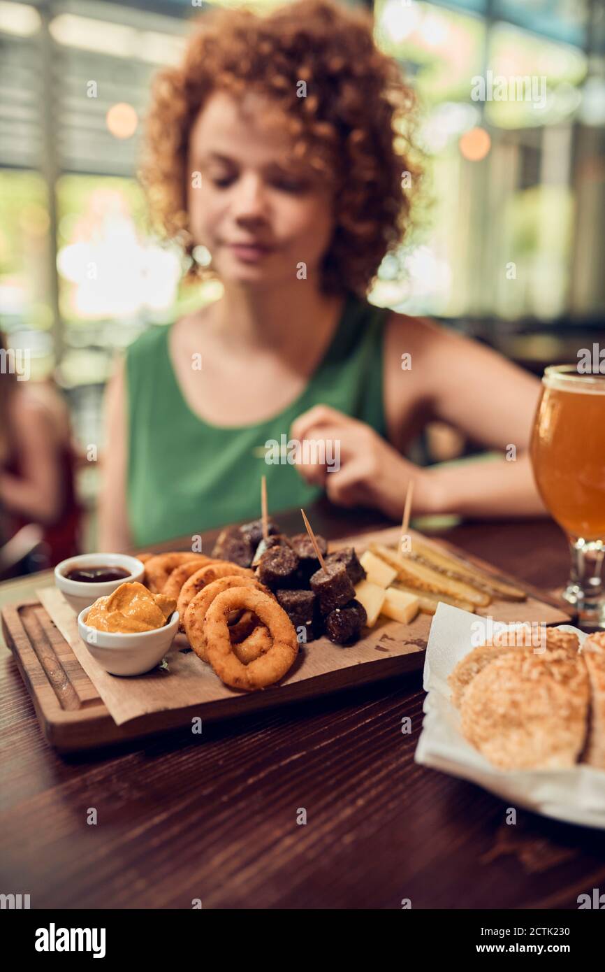 Woman having tapas in a pub Stock Photo - Alamy