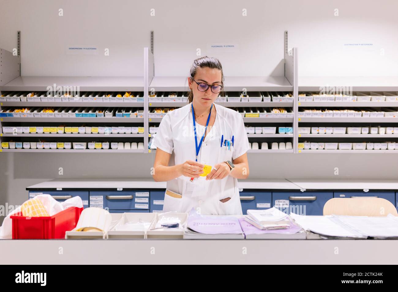 Female pharmacist packing medicines hi-res stock photography and images ...