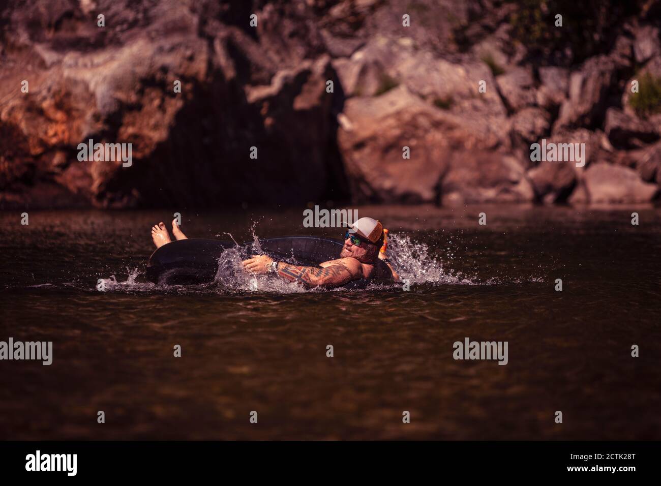 Man floating in an inner tube hi-res stock photography and images - Alamy