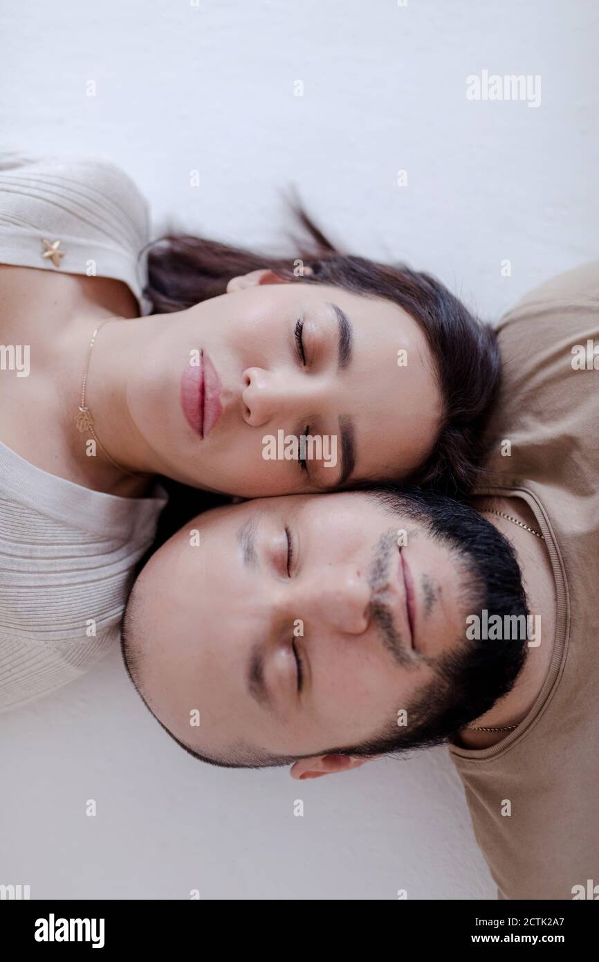 Man and woman lying on floor Stock Photo - Alamy