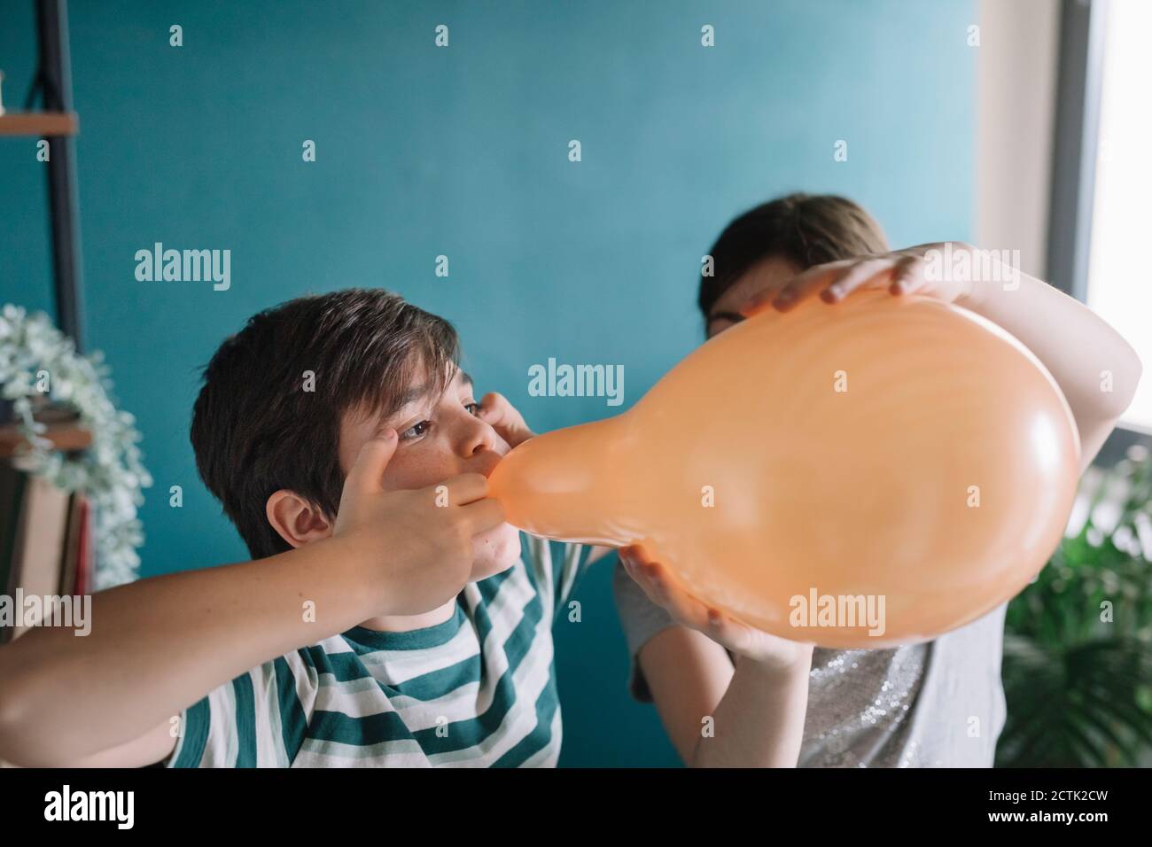 Child blowing up balloon hi-res stock photography and images - Alamy