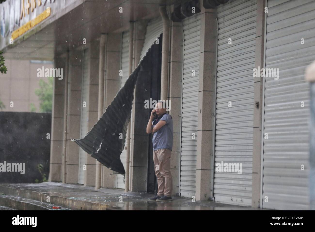 A mess of trees, utility poles and street lamps snapped by gust due to ...