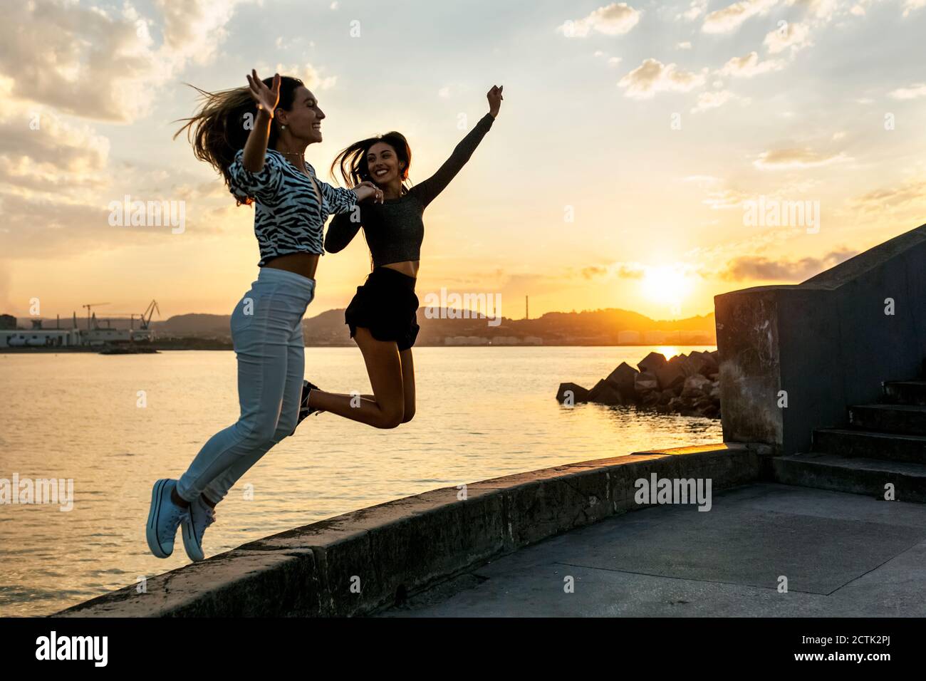 Women sunset jumping hi-res stock photography and images - Alamy