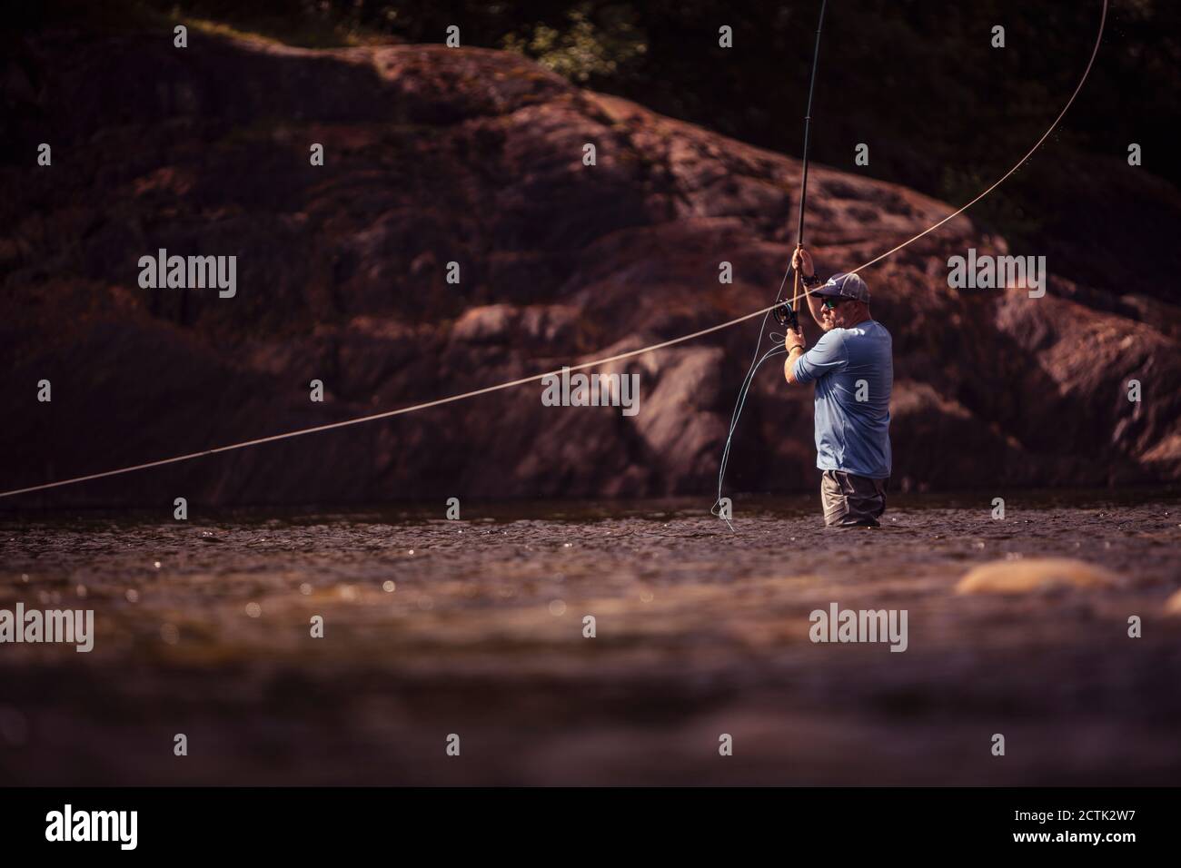 Fly fisherman casting with two handed rod in river Stock Photo - Alamy