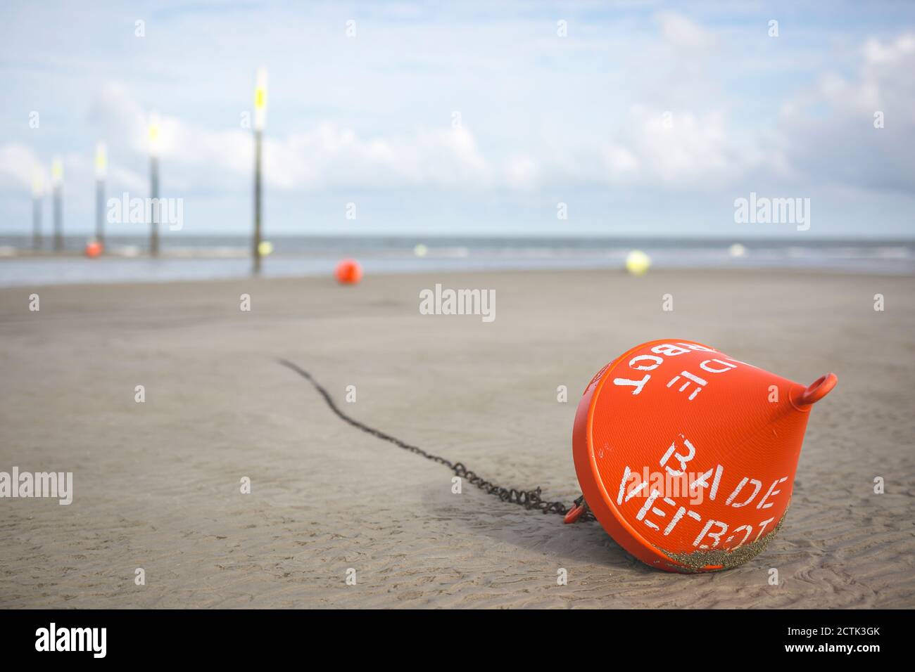 Red buoy lying on beach sand Stock Photo - Alamy