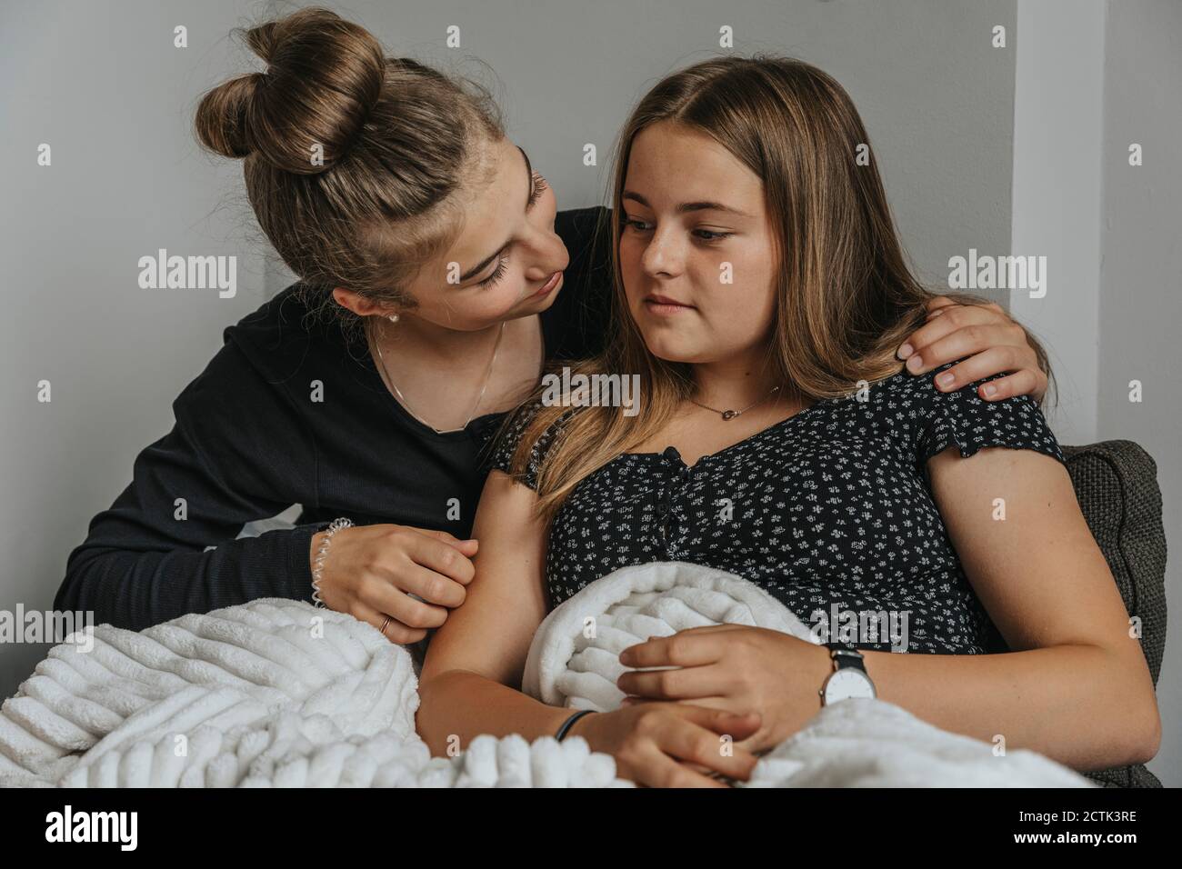 Girlfriend consoling sad teenage girl Stock Photo - Alamy