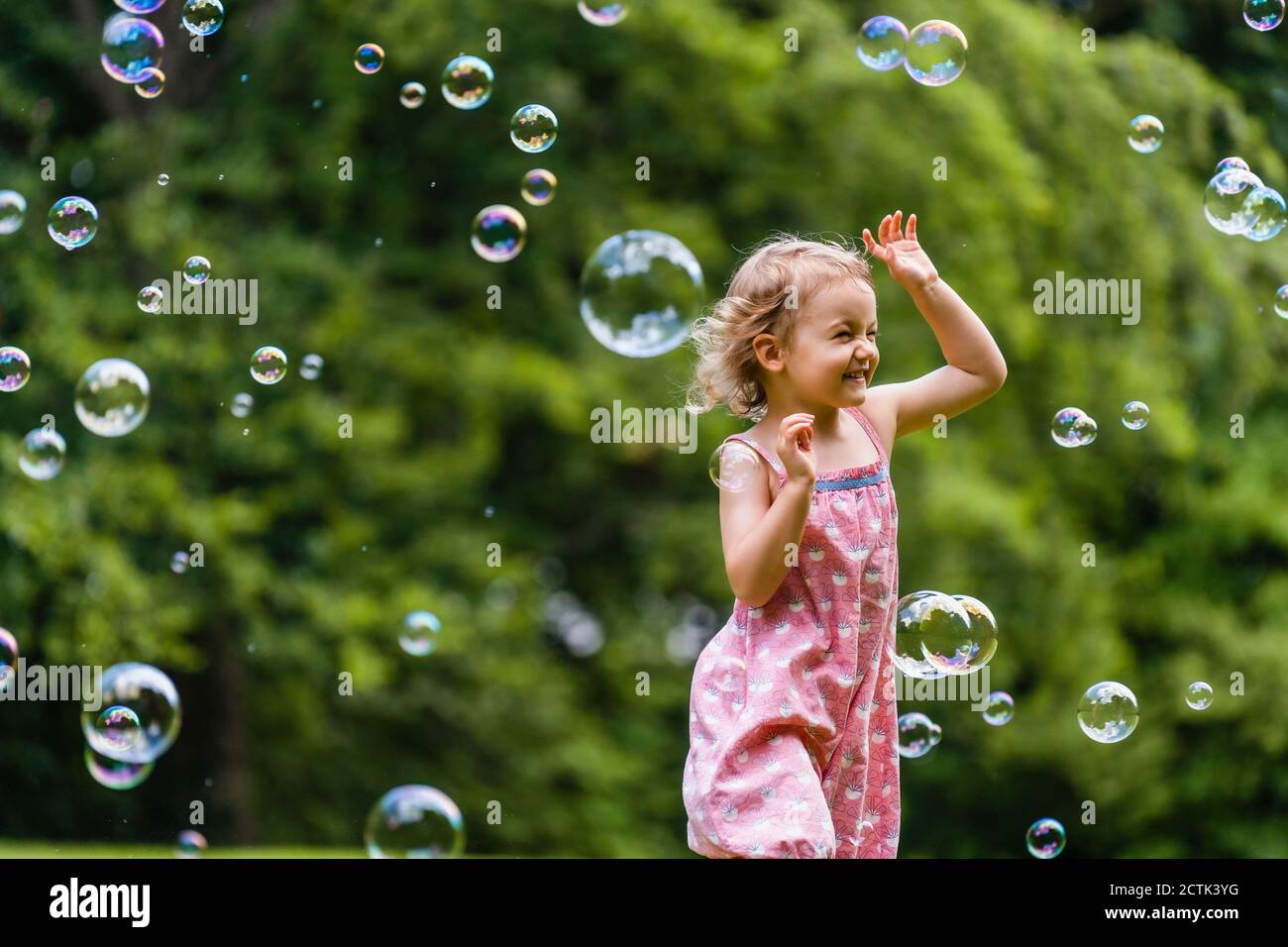Happy girl smiling soap bubbles hi-res stock photography and images - Alamy