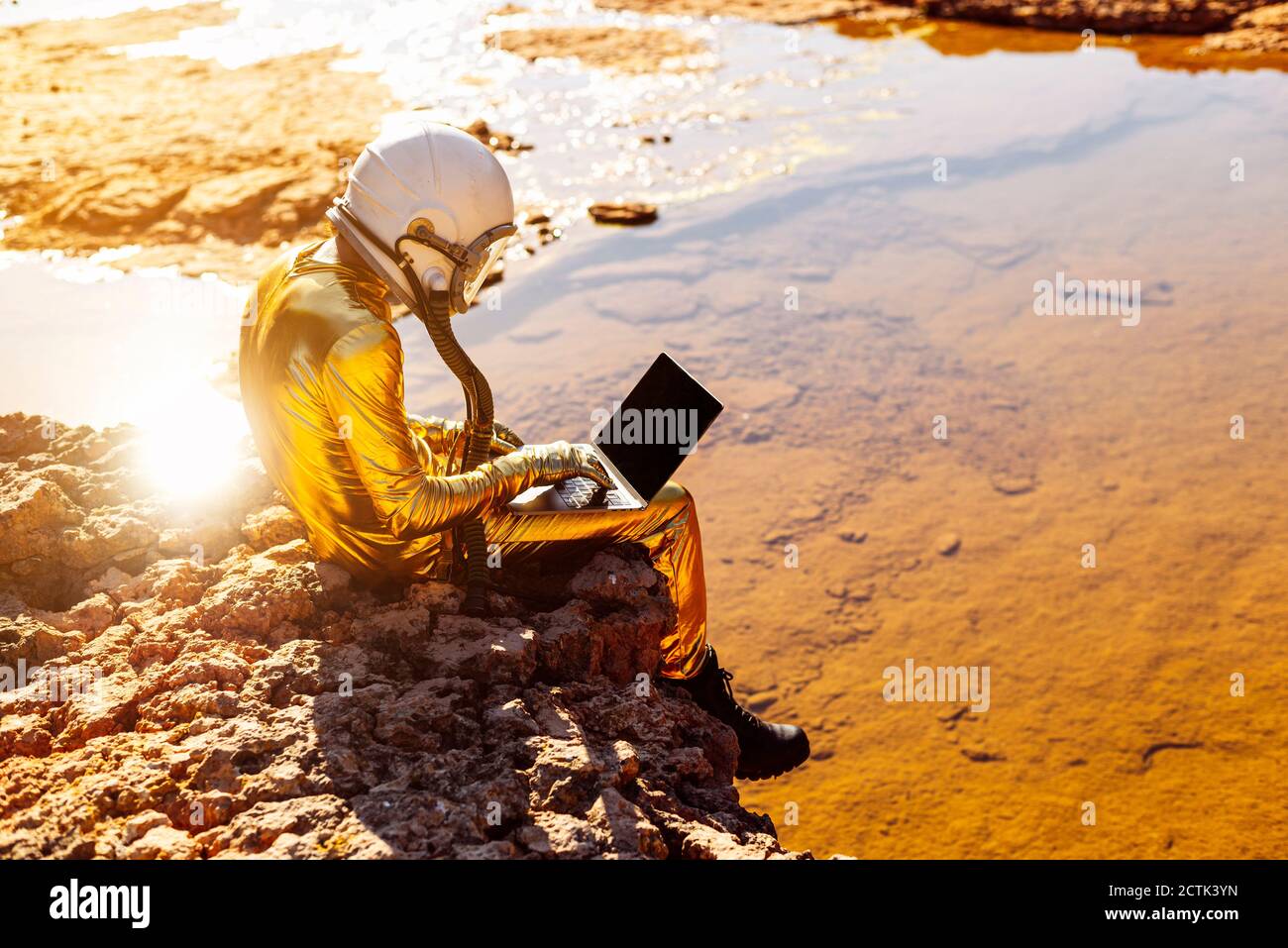 Astronaut working on laptop while on moon Stock Photo - Alamy
