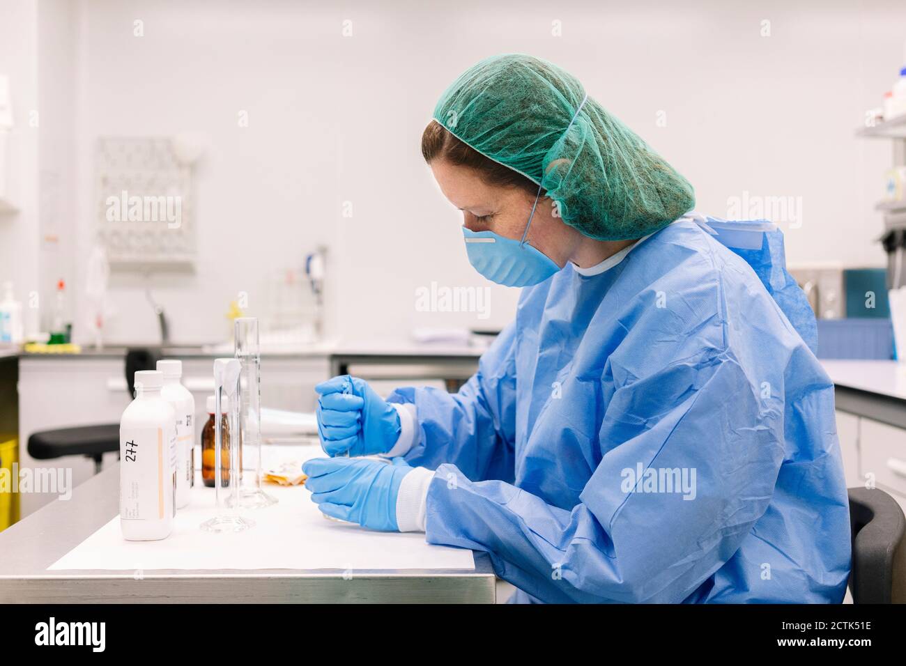 Female pharmacist preparing medicines on table in laboratory Stock ...
