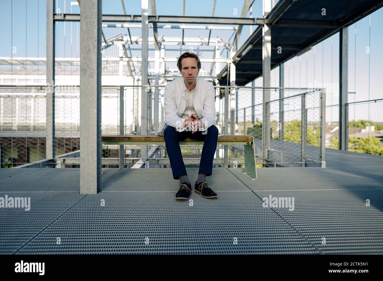 Scientist sitting on a bench having a break Stock Photo - Alamy