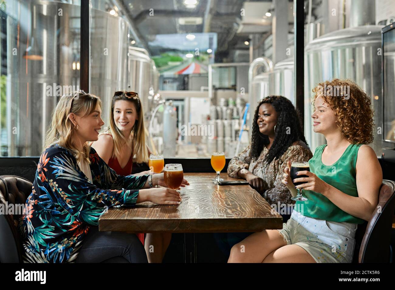 Female friends socializing in a pub Stock Photo - Alamy