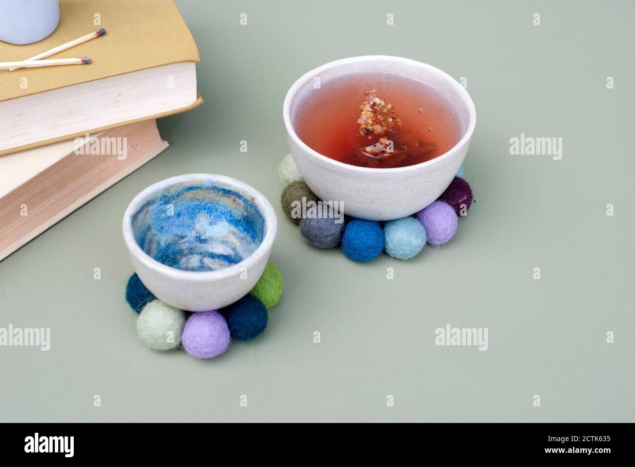 Bowls on DIY coasters made of felt balls Stock Photo - Alamy