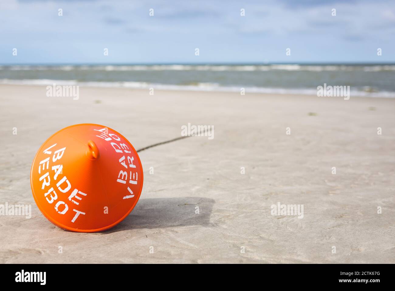 Red buoy lying on beach sand Stock Photo - Alamy