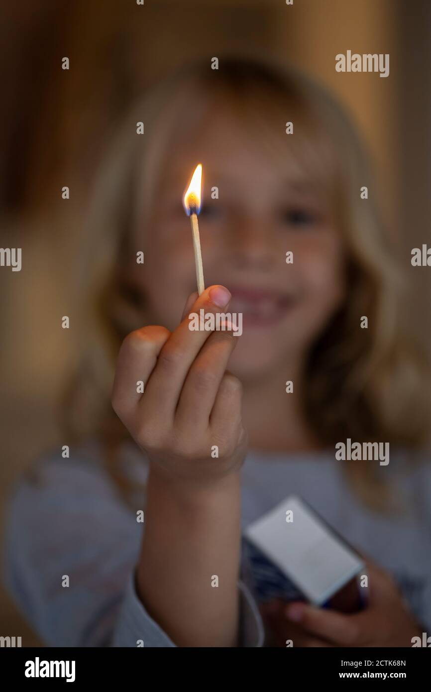 Little girl playing with matchstick Stock Photo - Alamy