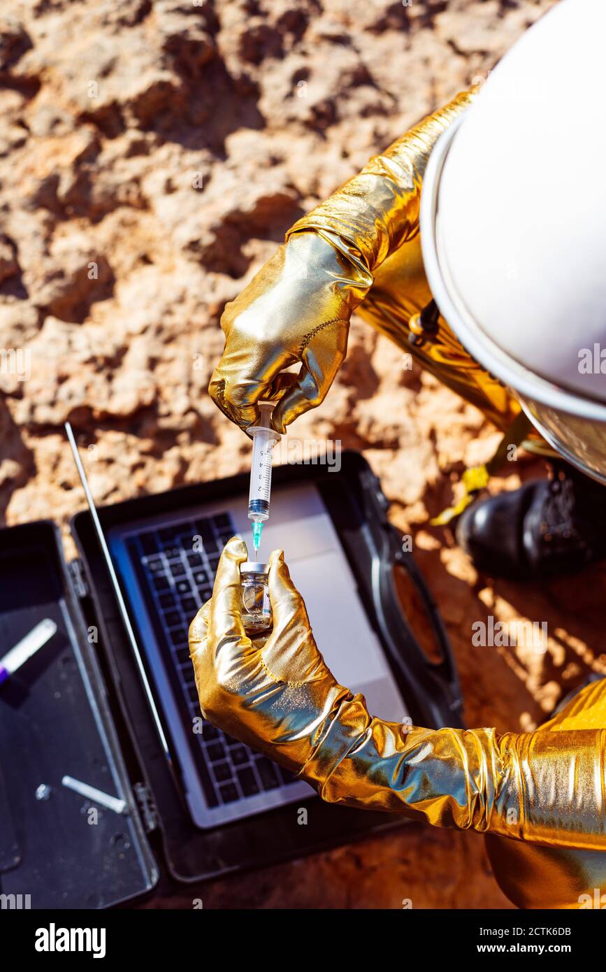 Close-up of astronaut doing experiment with syringe on moon Stock Photo ...
