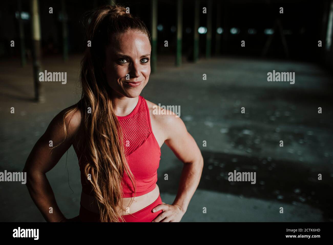 Athlete standing with hand no hip at abandoned factory Stock Photo - Alamy