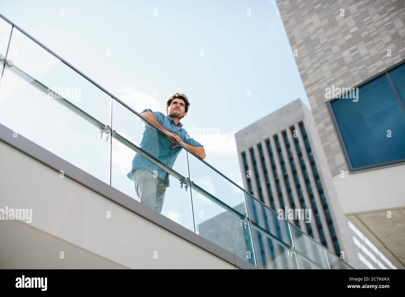 Man leaning against railing hi-res stock photography and images - Alamy