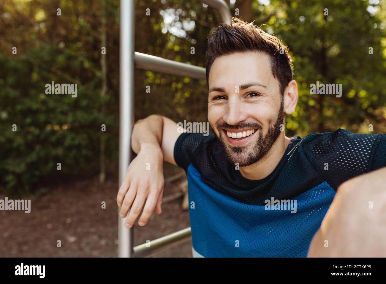 Portrait of happy man at fitness trail Stock Photo - Alamy