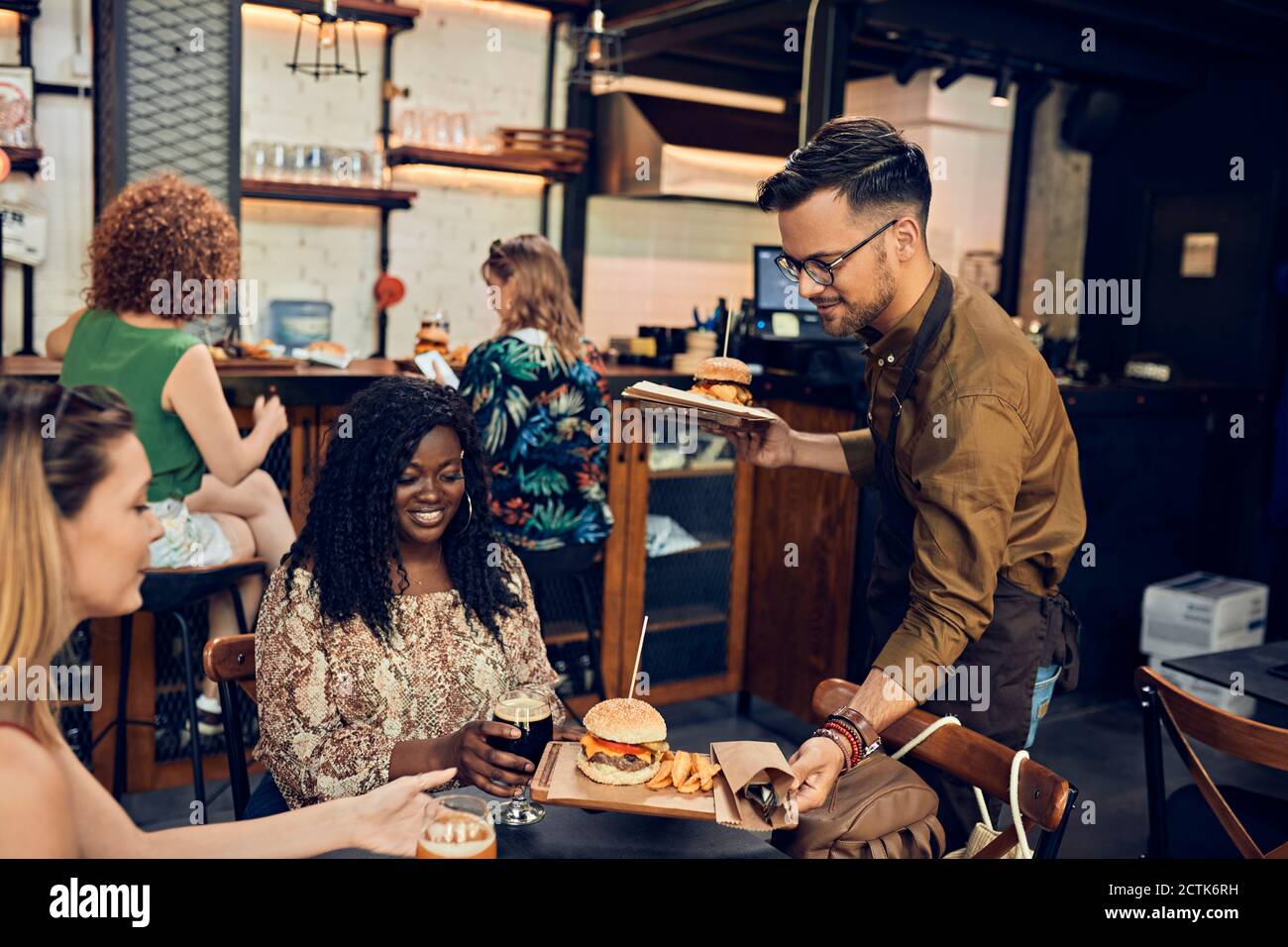 Woman serving men hi-res stock photography and images - Alamy
