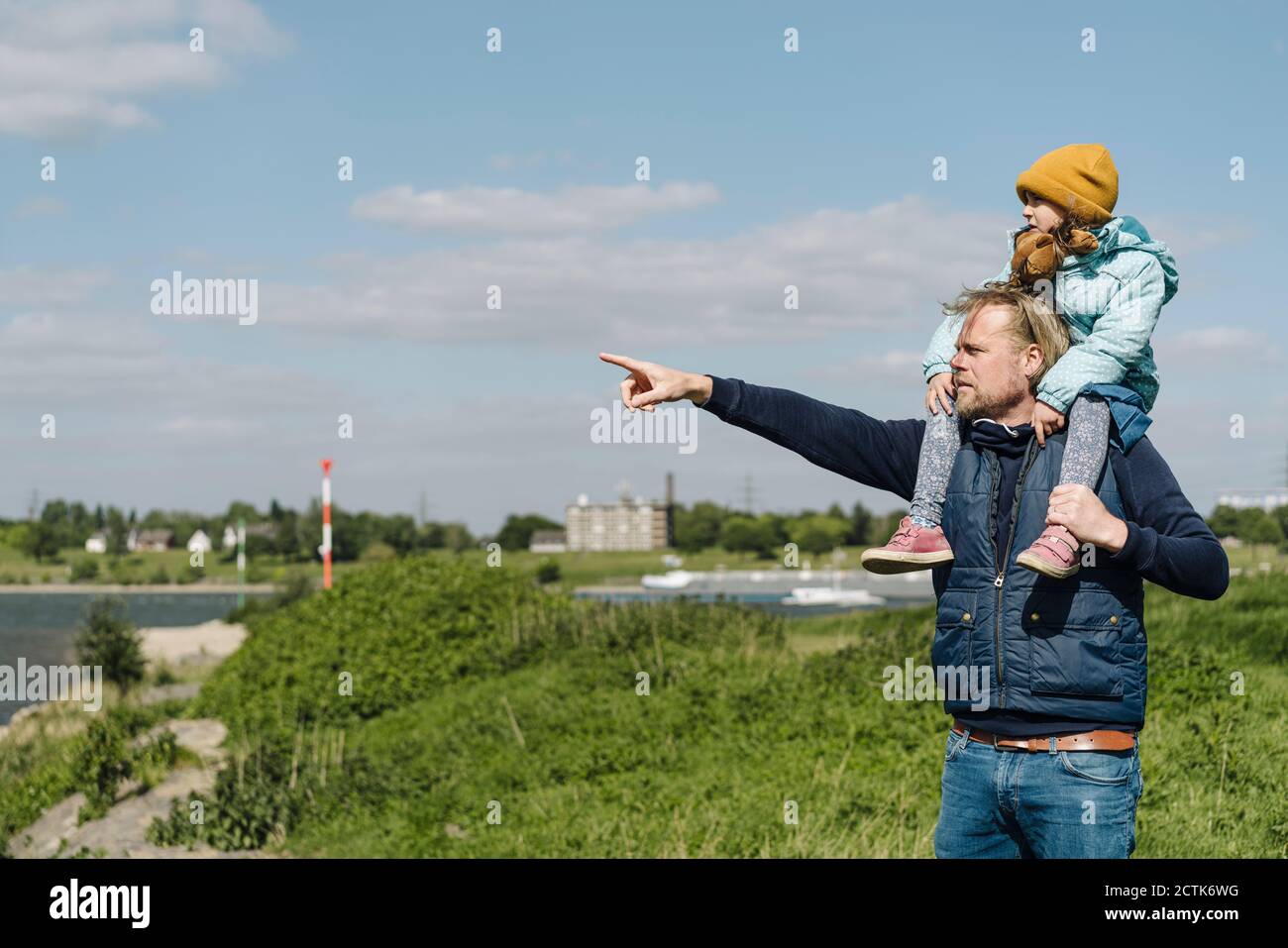 Father pointing at Rhine river while taking daughter on shoulder Stock ...