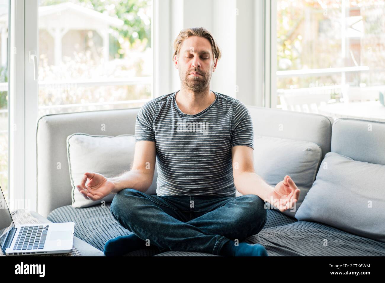 Person on computer meditating hi-res stock photography and images - Alamy