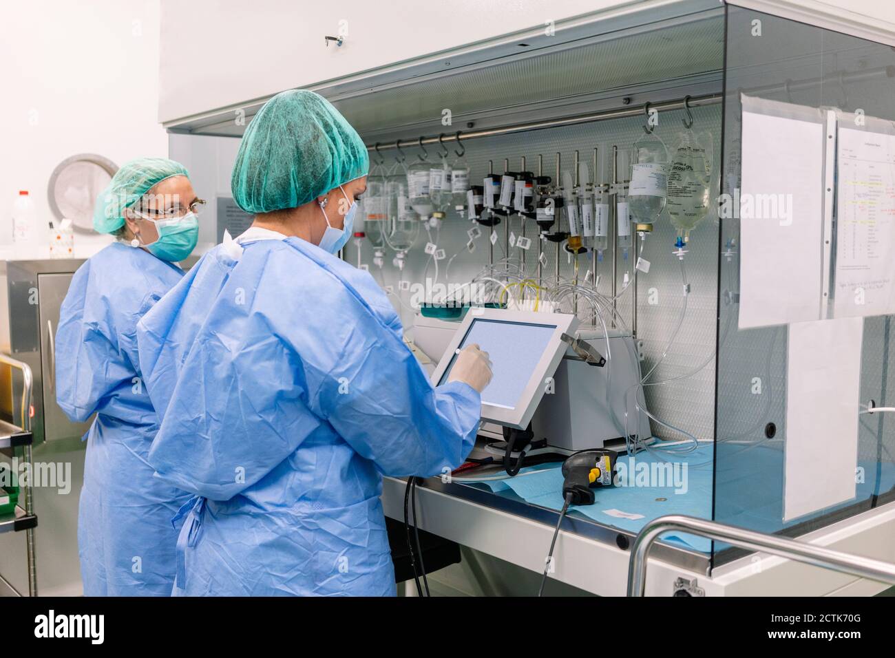 Female doctors working by drips in laboratory Stock Photo - Alamy