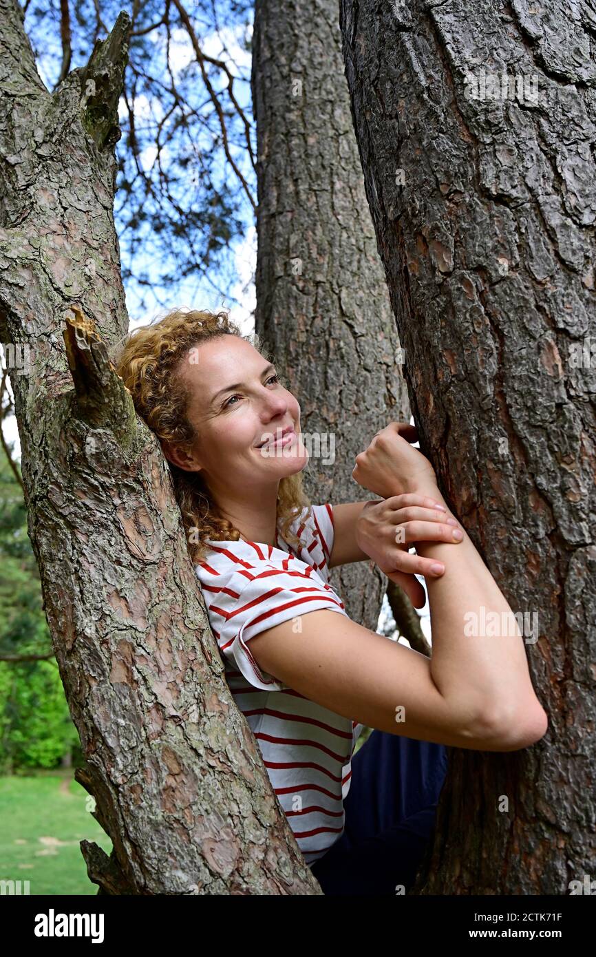 Adult sitting in tree hi-res stock photography and images - Alamy