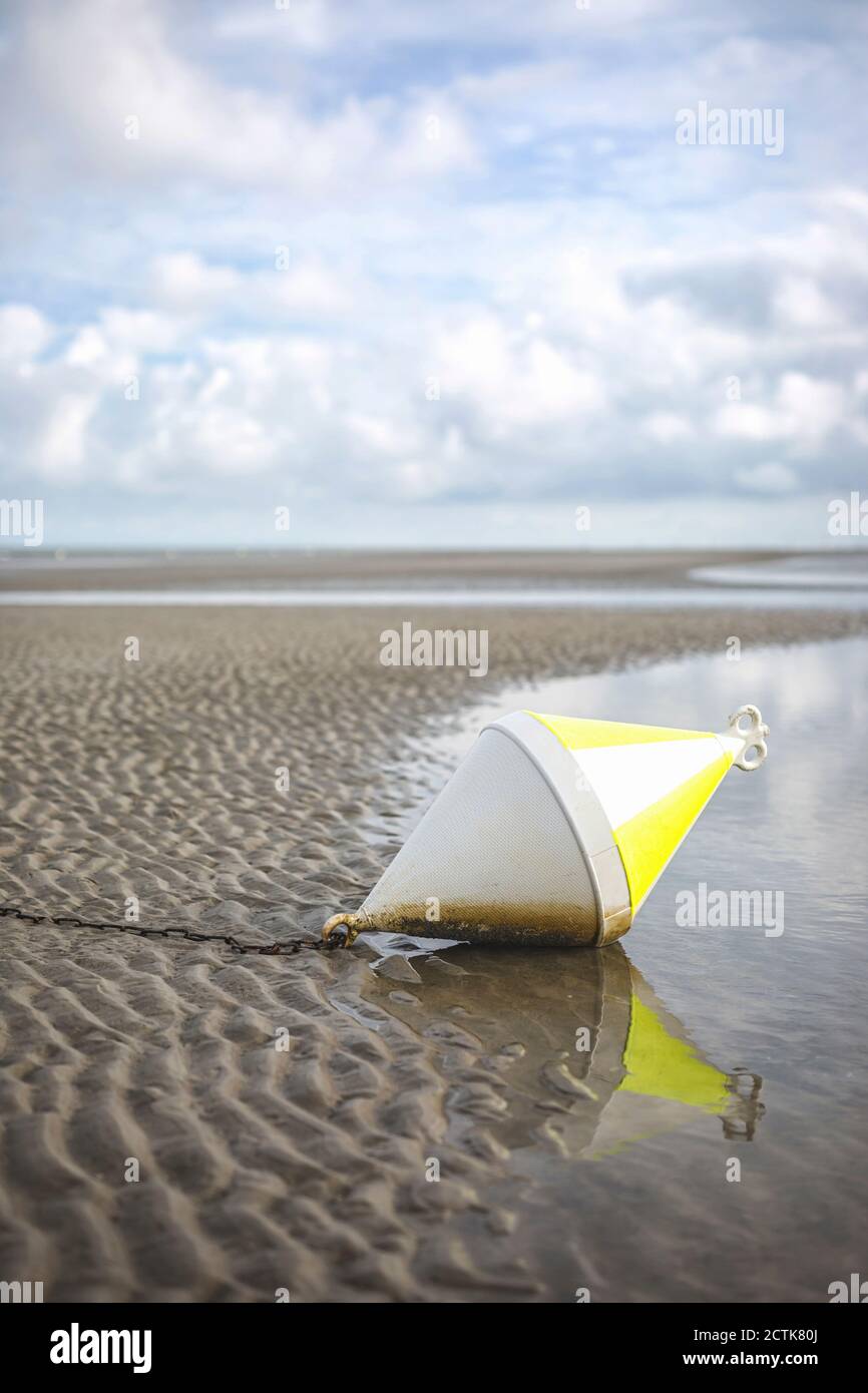 Buoy lying on beach sand Stock Photo - Alamy