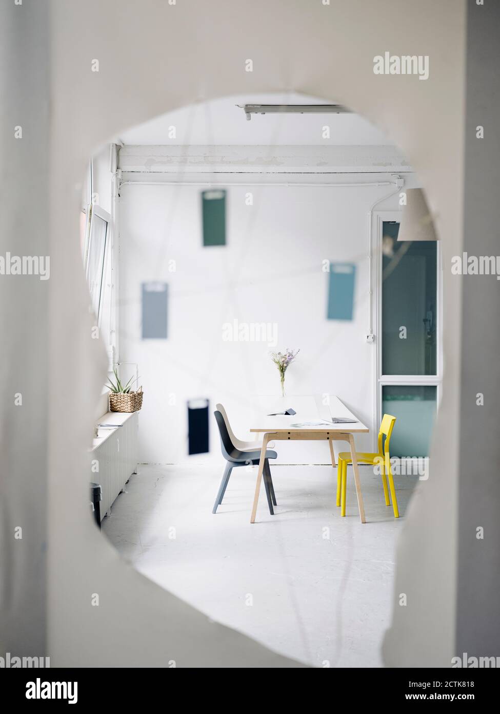 Chairs and table arranged in loft office seen through window Stock ...