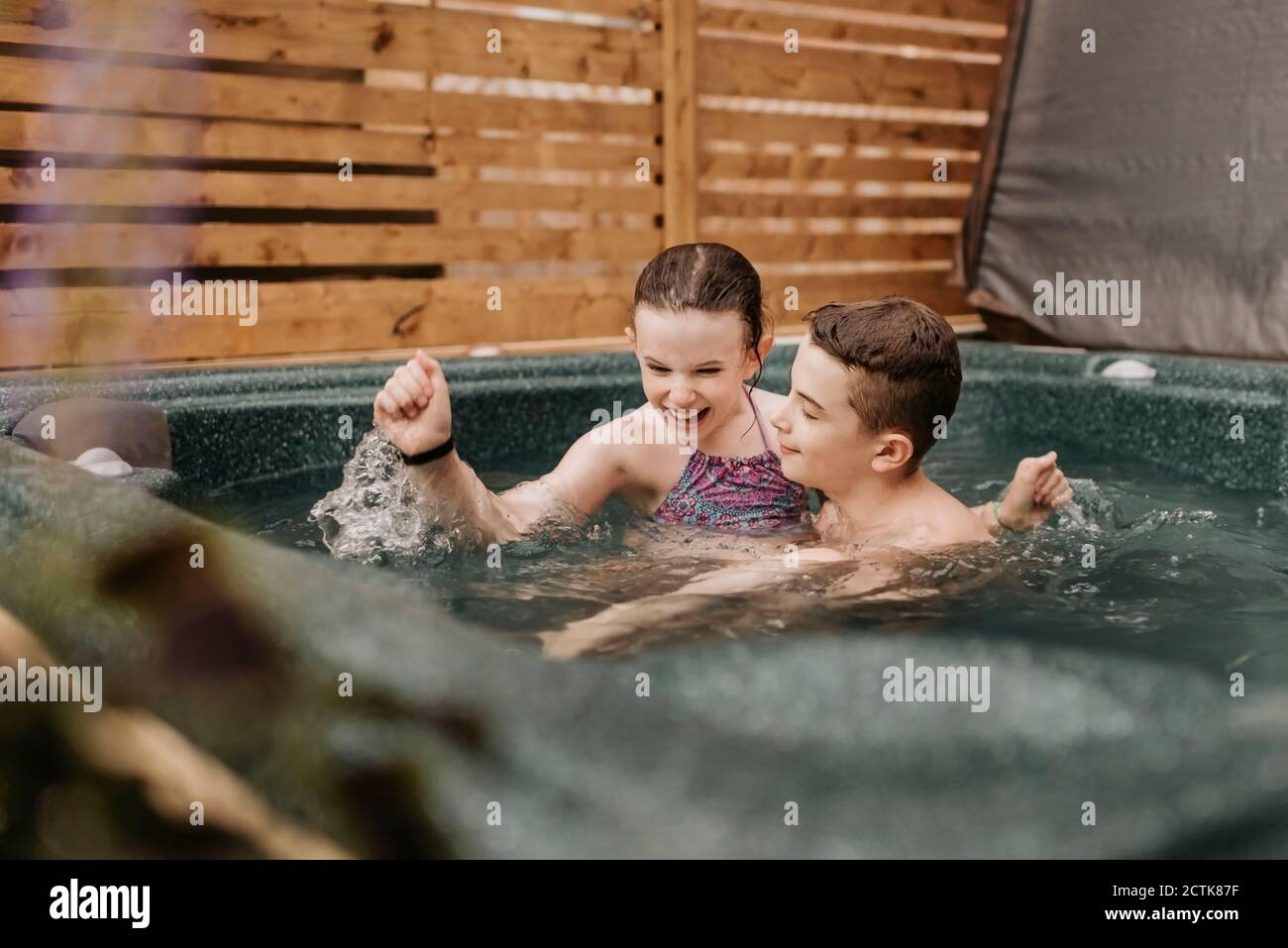 Brother sister playing in pool hi-res stock photography and images - Alamy