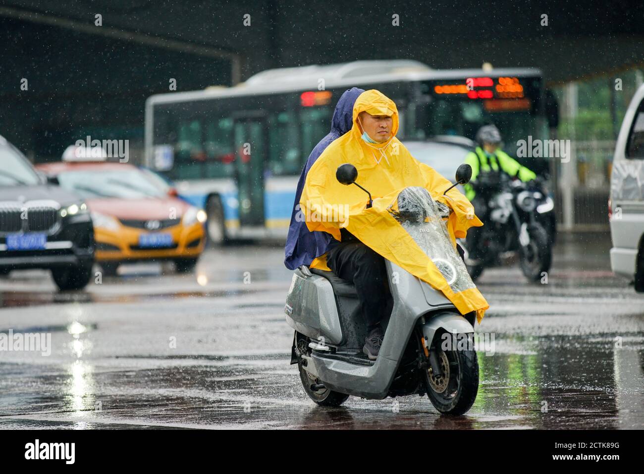 Motor, pedestrians and vehicles trek in the downpour, Beijing, China ...