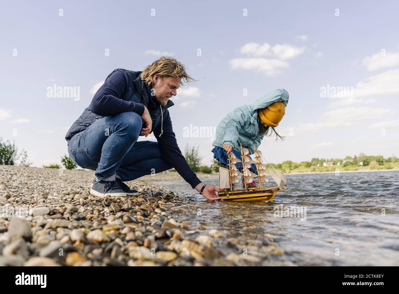 Children playing with sailing boat hi-res stock photography and images ...