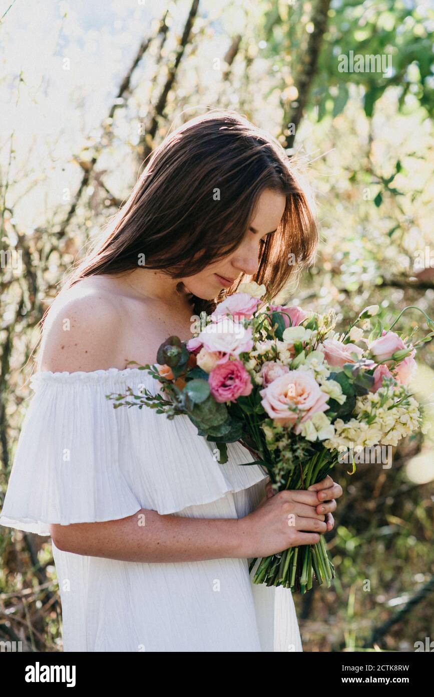 Woman smelling fresh flower bouquet Stock Photo - Alamy