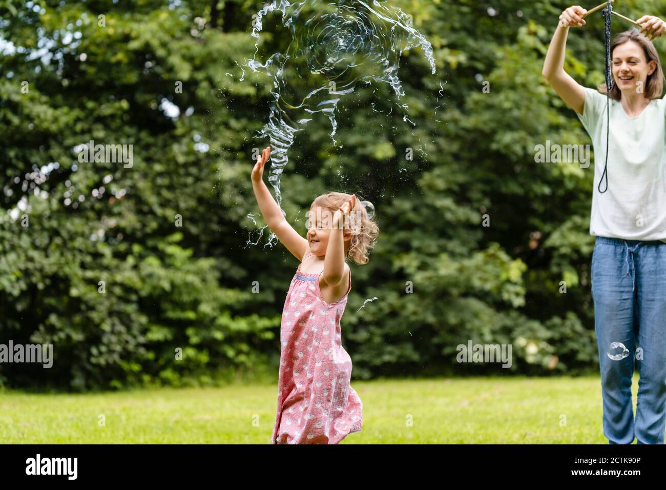Girl exploding bubble while enjoying at public park Stock Photo - Alamy