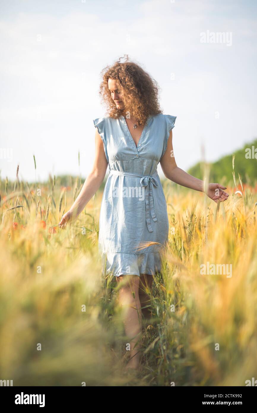 Beautiful young woman walking field hi-res stock photography and images ...