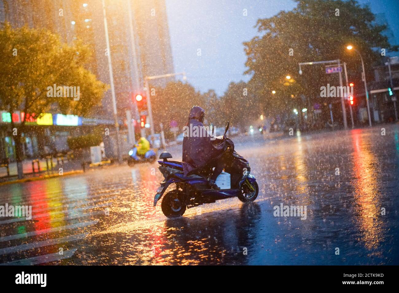 Motor, pedestrians and vehicles trek in the downpour, which might be ...