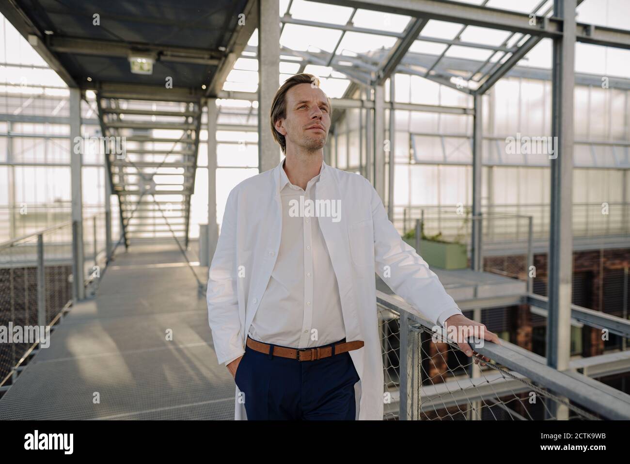 Confident scientist standing on a bridge Stock Photo - Alamy