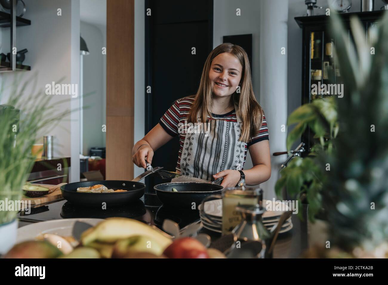 Teenage girl preparing healthy lunch in kitchen Stock Photo - Alamy